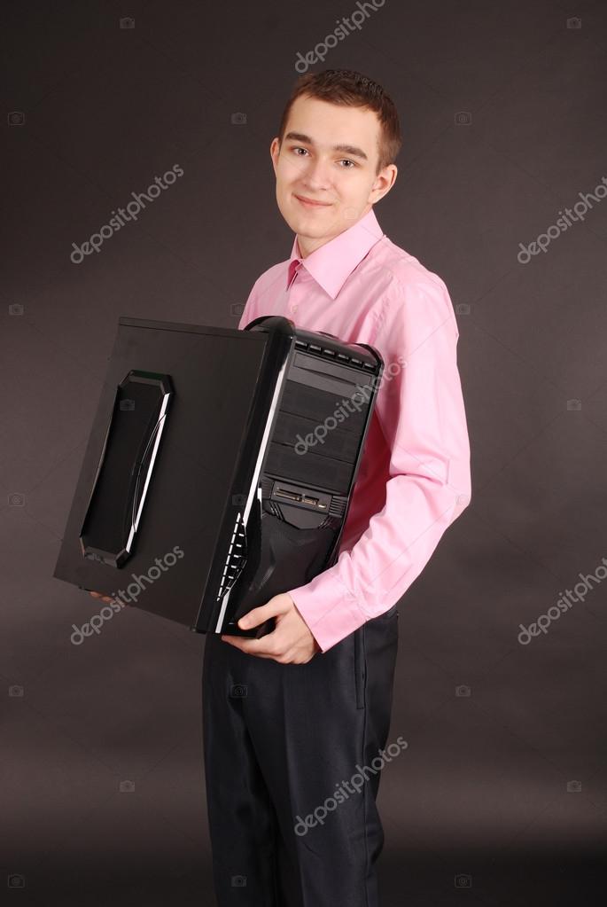 Young man holding a pc black background with soft shadow Stock Photo by ...