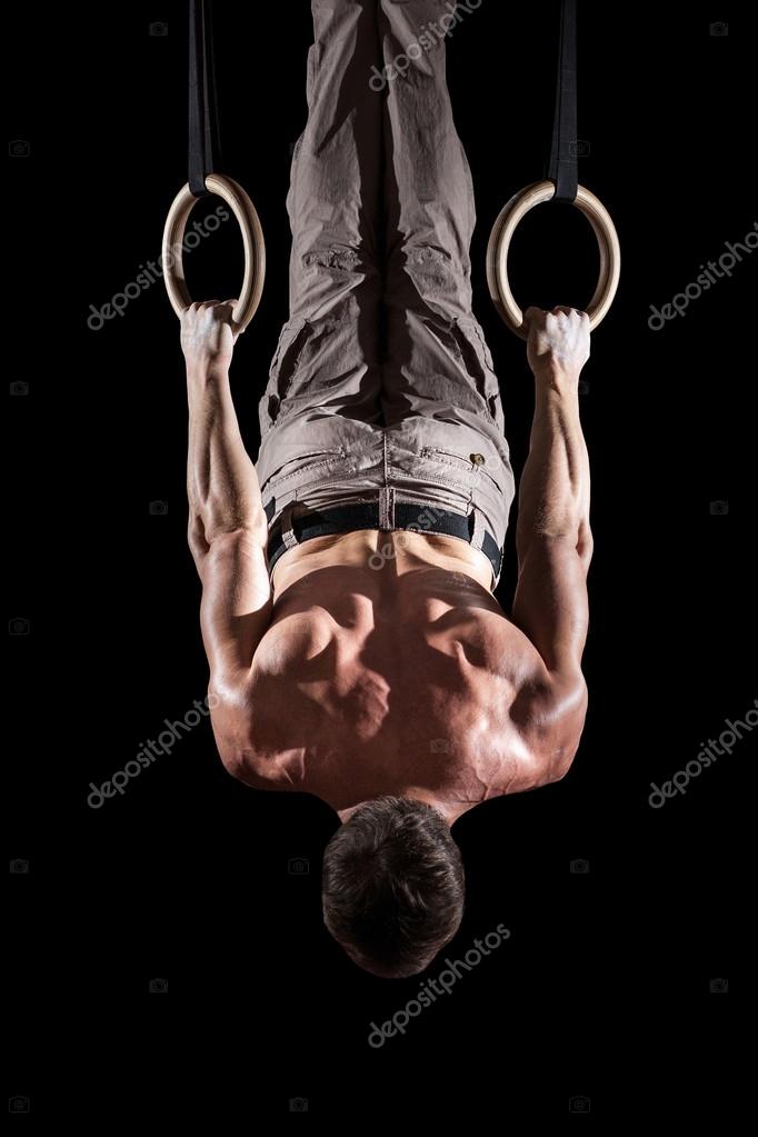 Athlete practicing on the rings Stock Photo by ©PavelSh 60642419