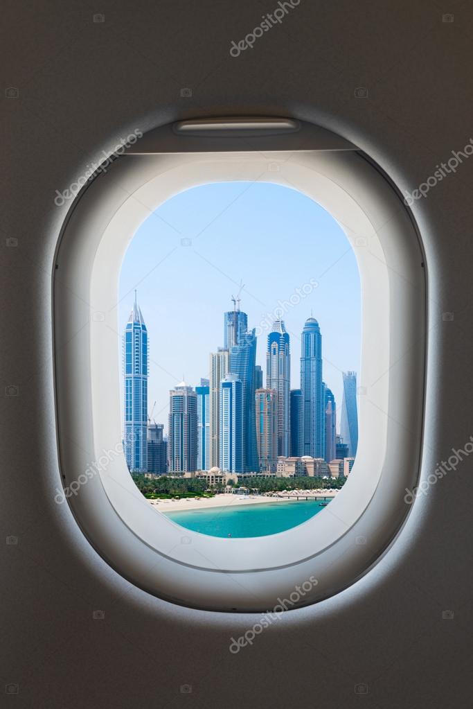 Airplane window from interior of aircraft with modern city view. Stock ...