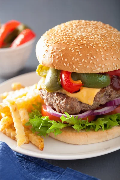 homemade cheese burger with peppers tomato onion - Stock Image - Everypixel