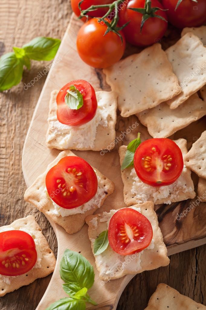 Crackers with soft cheese and tomatoes. healthy appetizer Stock Photo ...