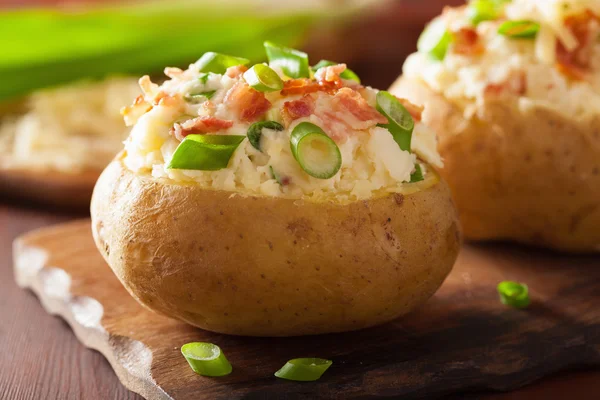 Baked potato in jacket with bacon and cheese - Stock Image - Everypixel