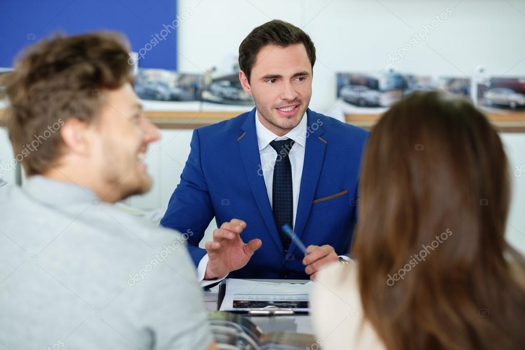 Salesman talking to a young couple Stock Photo by ©nejron 110289740