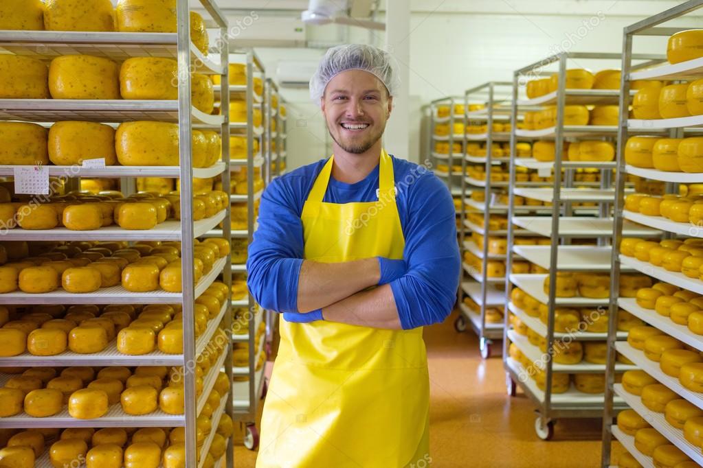 Cheesemaker is checking cheeses — Stock Photo © nejron #115446724