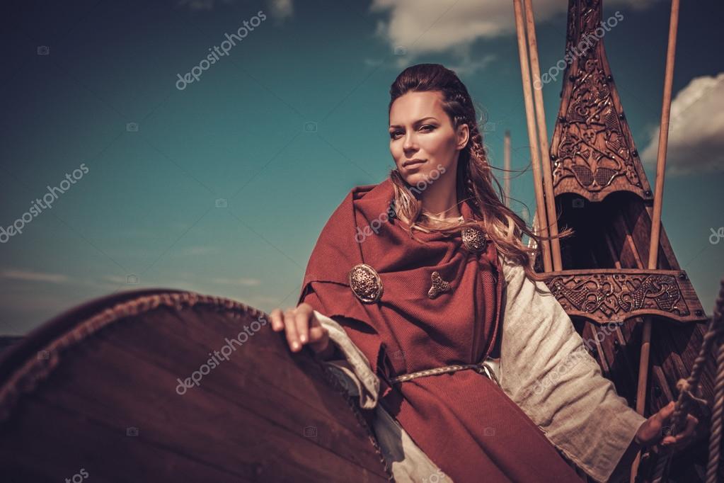 Viking woman with shield on Drakkar. Stock Photo by ©nejron 124006098