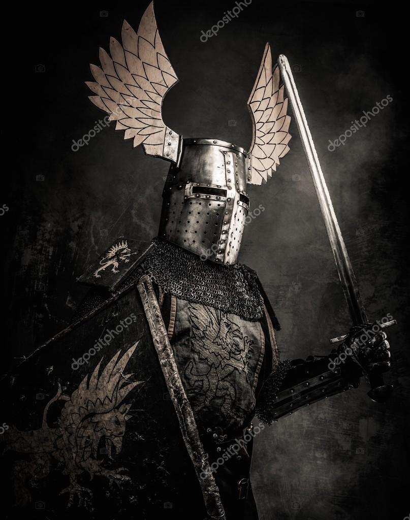 Medieval knight with sword and shield against stone wall Stock Photo by ...