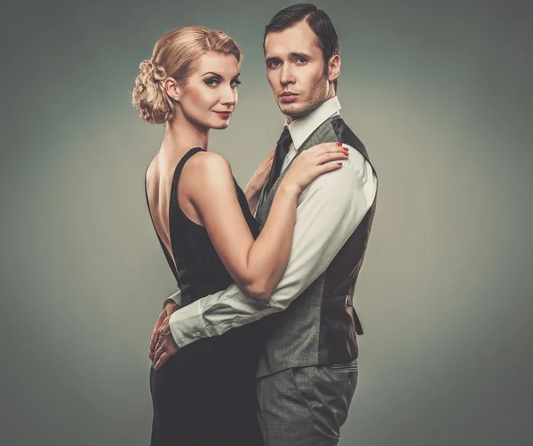Well-dressed retro couple on grey background Stock Photo by ©nejron ...