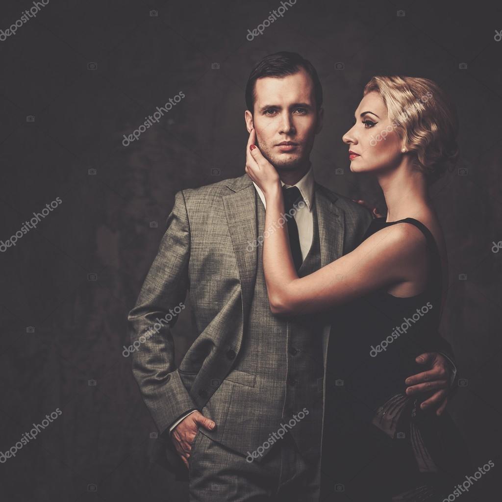 Well-dressed retro couple on grey background Stock Photo by ©nejron ...