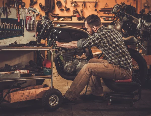Mechanic and vintage style cafe-racer motorcycle - Stock Image - Everypixel