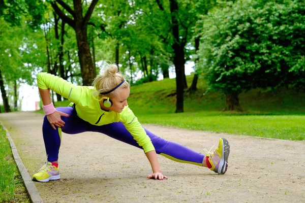 Woman doing stretching exercise before running - Stock Image - Everypixel