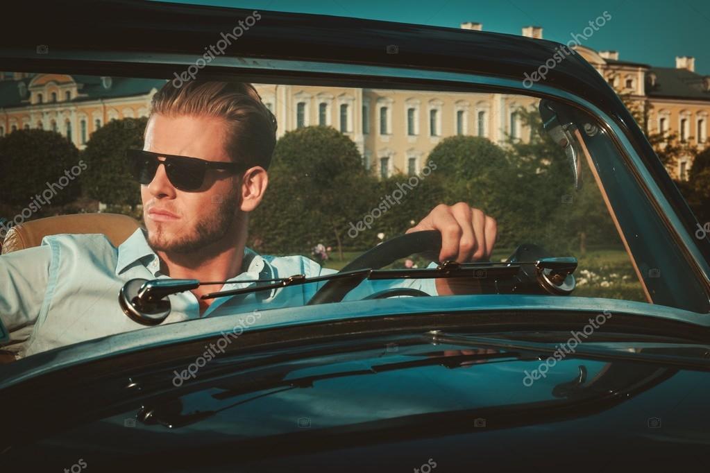 Man behind classic convertible steering wheel — Stock Photo © nejron ...