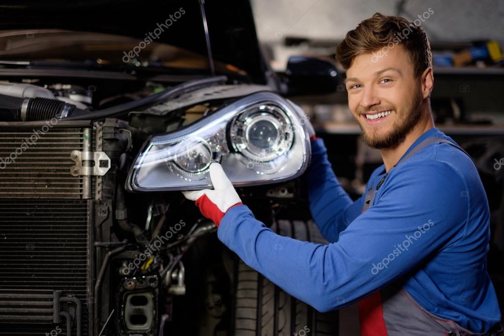 Mechanic with new car headlight in a workshop Stock Photo by ©nejron ...