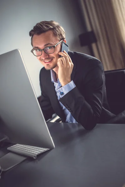 A man in eyeglasses working on computer. - Stock Image - Everypixel