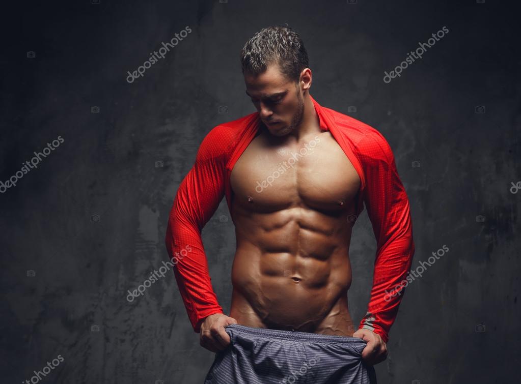 Abdominal bodybuilder model in red jersey — Stock Photo © fxquadro ...