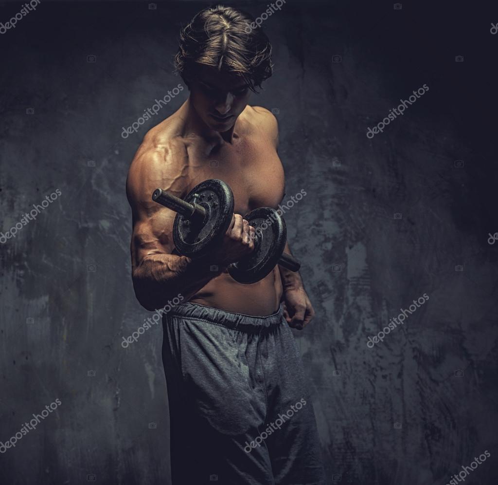 Muscular guy doing biceps exercise. Stock Photo by ©fxquadro 107691920