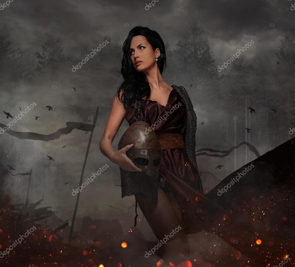 Attractive war queen holding helmet Stock Photo by ©fxquadro 116413042