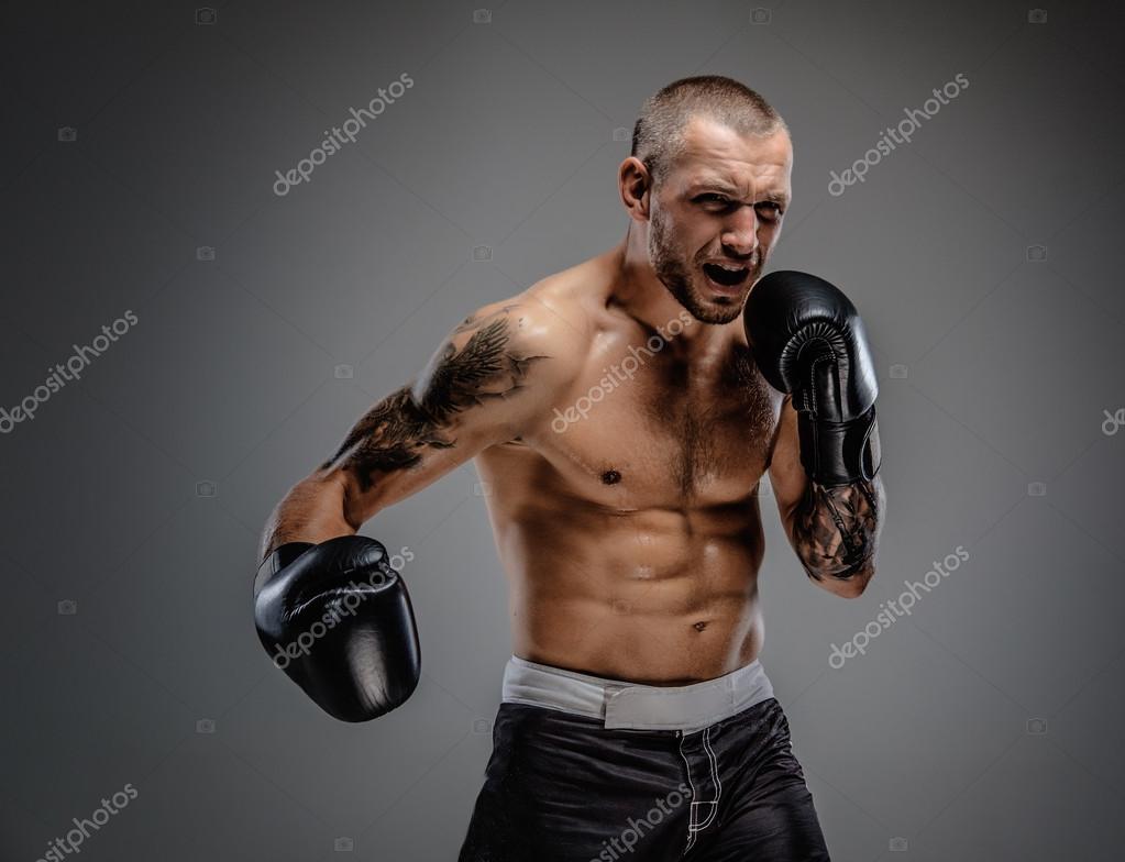 Aggressive tattooed fighter Stock Photo by ©fxquadro 119894538