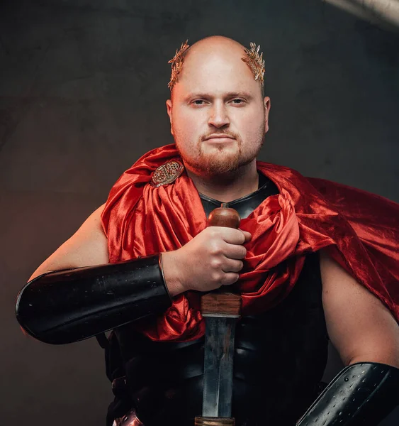 Bald roman warrior poses with crossed arms in dark background Stock ...