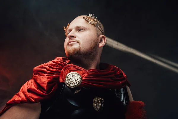 Bald roman warrior poses with crossed arms in dark background Stock ...