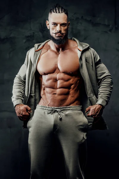 Brutal bodybuilder with beard posing with hairbrush in studio Stock ...
