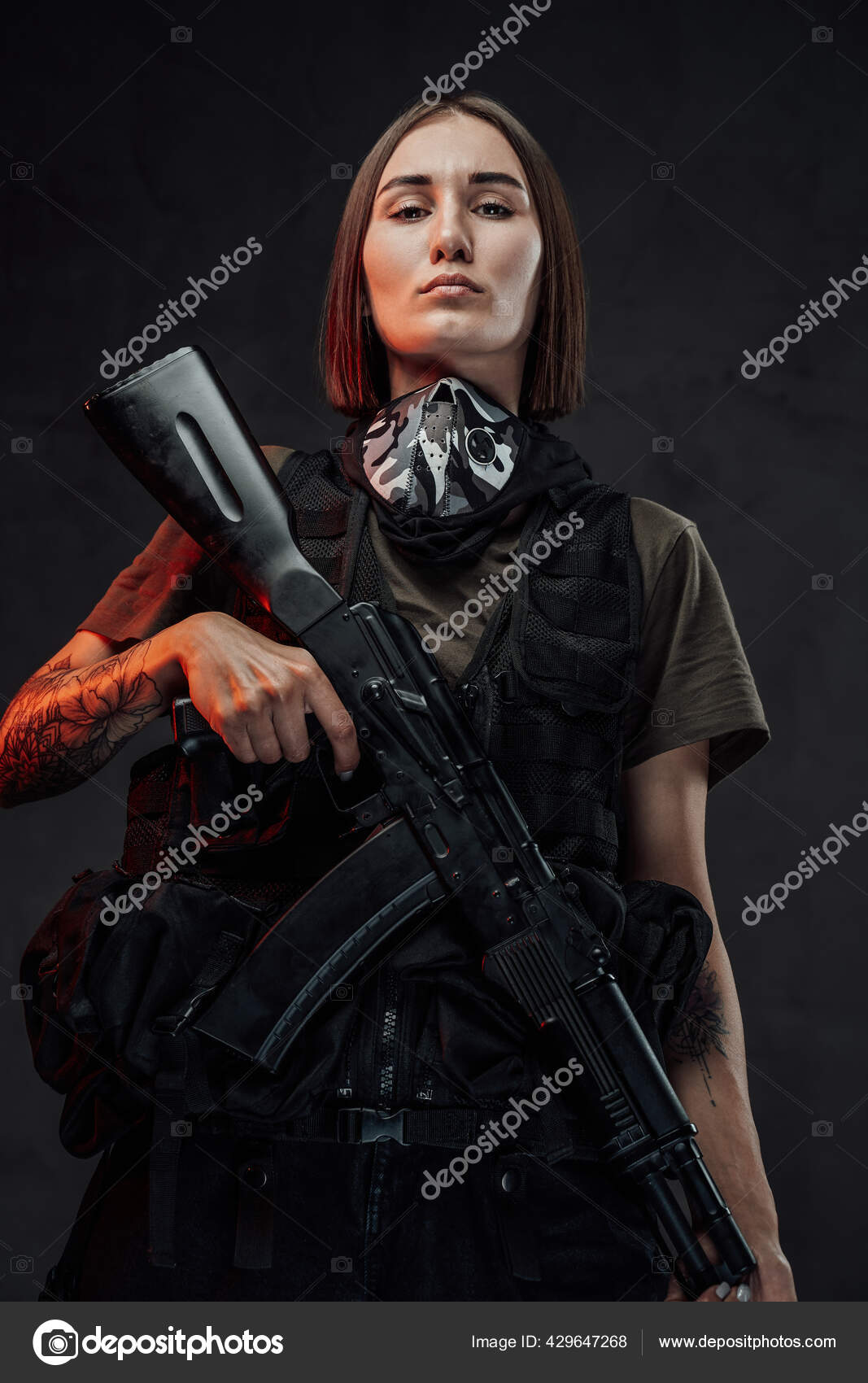 Cheerful female mercenary with assault rifle in dark background Stock ...
