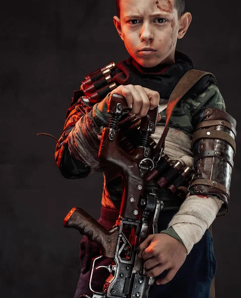 Armed with shotgun kid poses in dark background looking at camera Stock ...