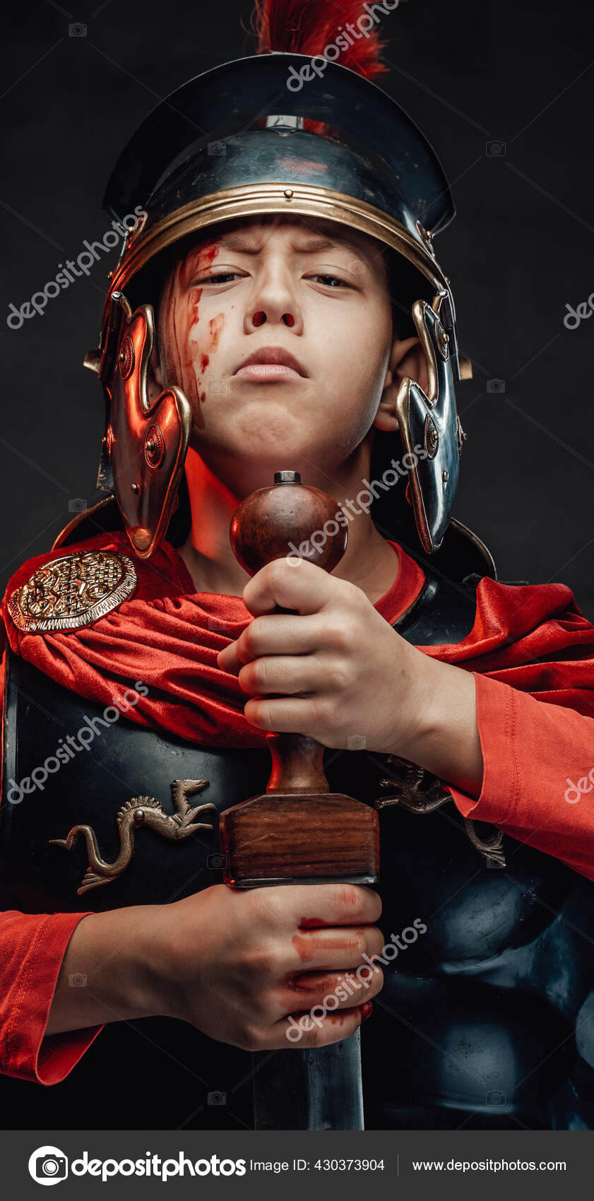 Cheerful boy dressed like legionary poses with sword Stock Photo by ...