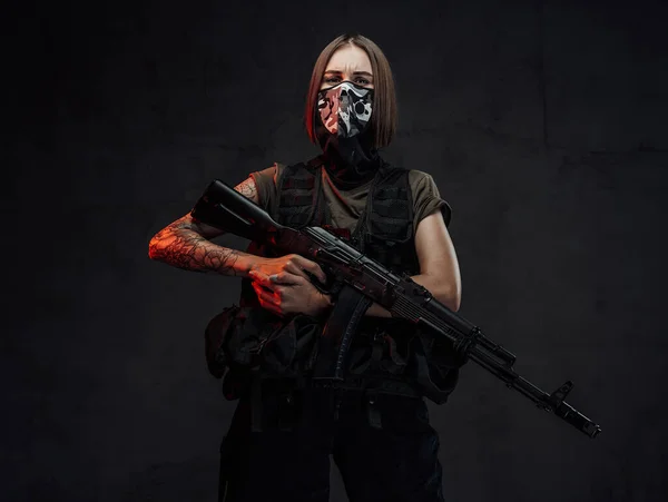 Cheerful female mercenary with assault rifle in dark background Stock ...
