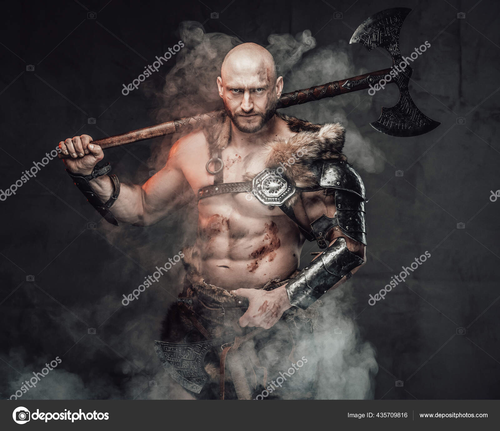 Holding axe on his shoulder savage nordic warrior in smokey background ...