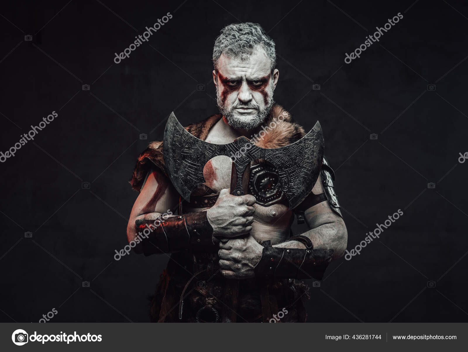 Savage warrior from the past with his axe in dark background Stock ...