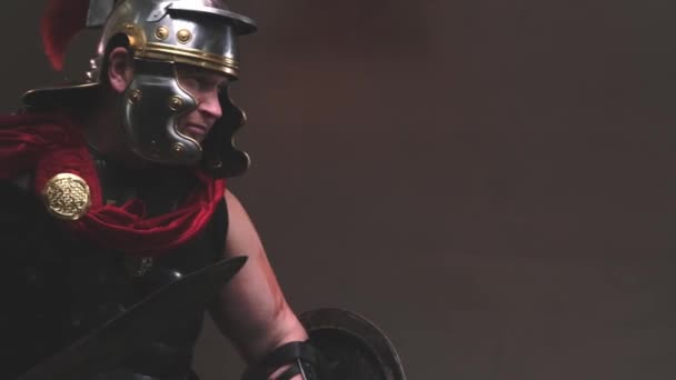 Screaming violent roman soldier pulls out his sword and points it ...