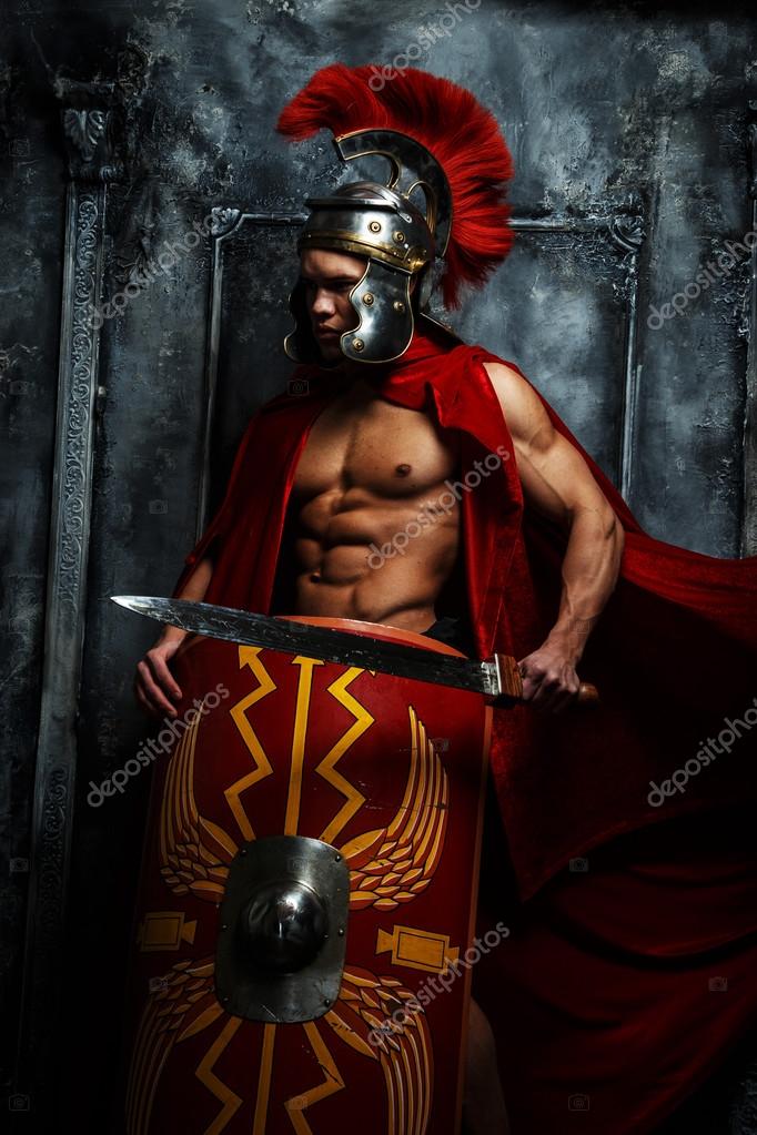 Muscular Roman posing on grey background. Stock Photo by ©fxquadro 61687555