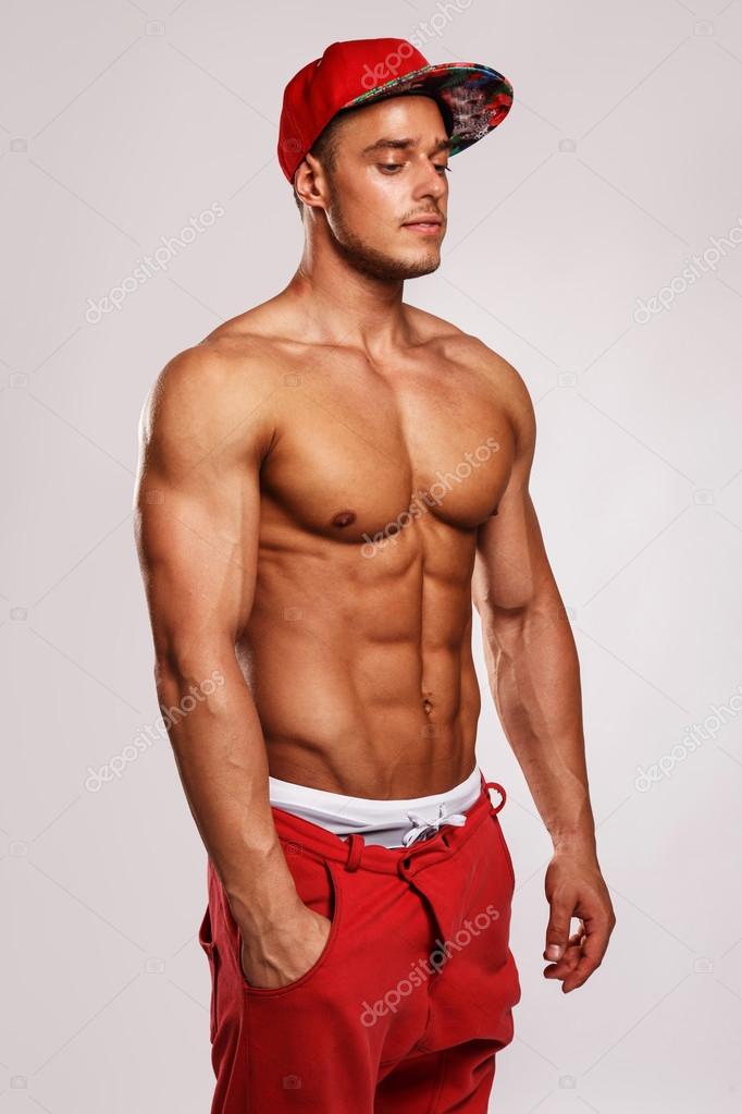 Muscular man in red cap. Stock Photo by ©fxquadro 64432093