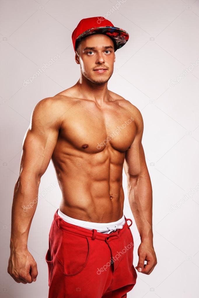 Muscular man in red cap. Stock Photo by ©fxquadro 64433023
