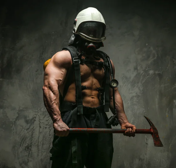 Muscular firefighter with axe — Stock Photo © fxquadro #68185591
