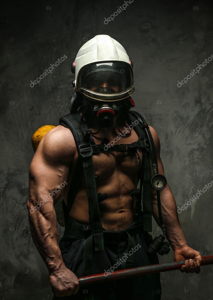 Muscular firefighter with axe Stock Photo by ©fxquadro 68185459