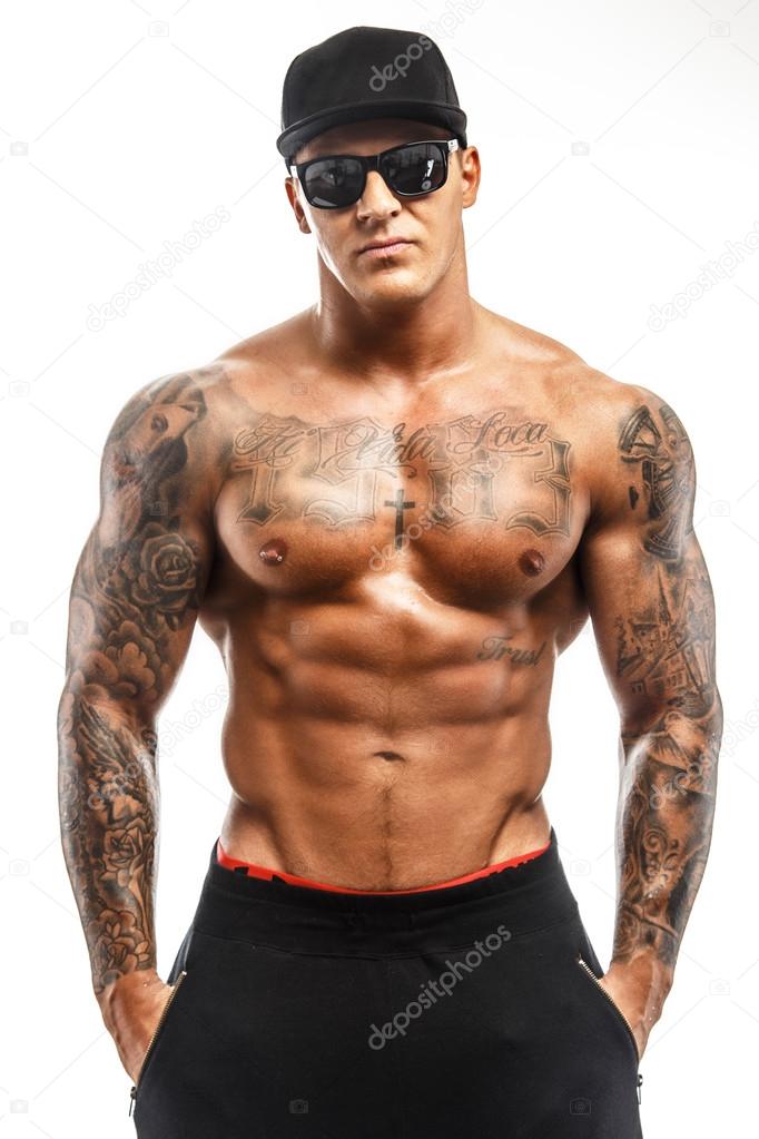 Muscular macho man posing in studio Stock Photo by ©fxquadro 73074475