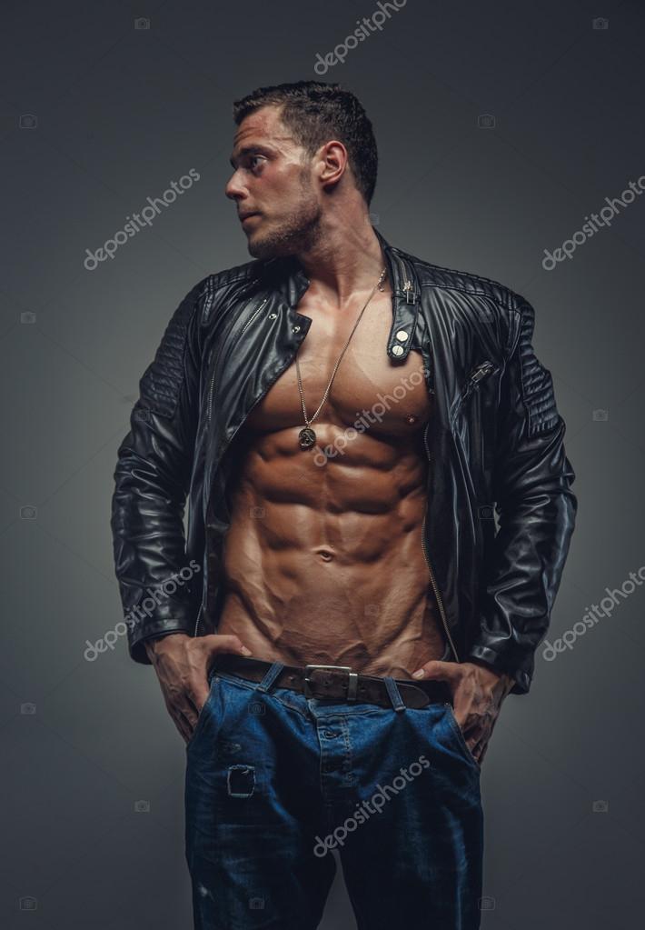 Bodybuilder in blue jeans and black jacket. Stock Photo by ©fxquadro ...