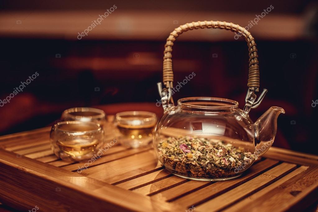 Glass chinese teapot with herbs — Stock Photo © fxquadro #77251114