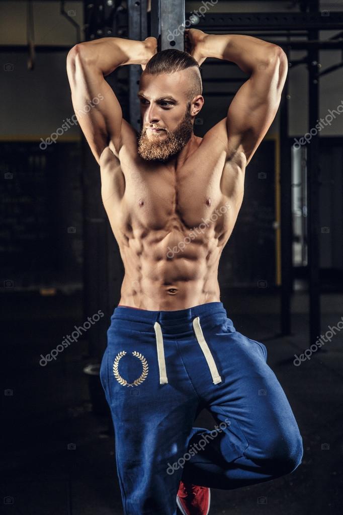 Bodybuilder with beard in a gym. Stock Photo by ©fxquadro 83506662