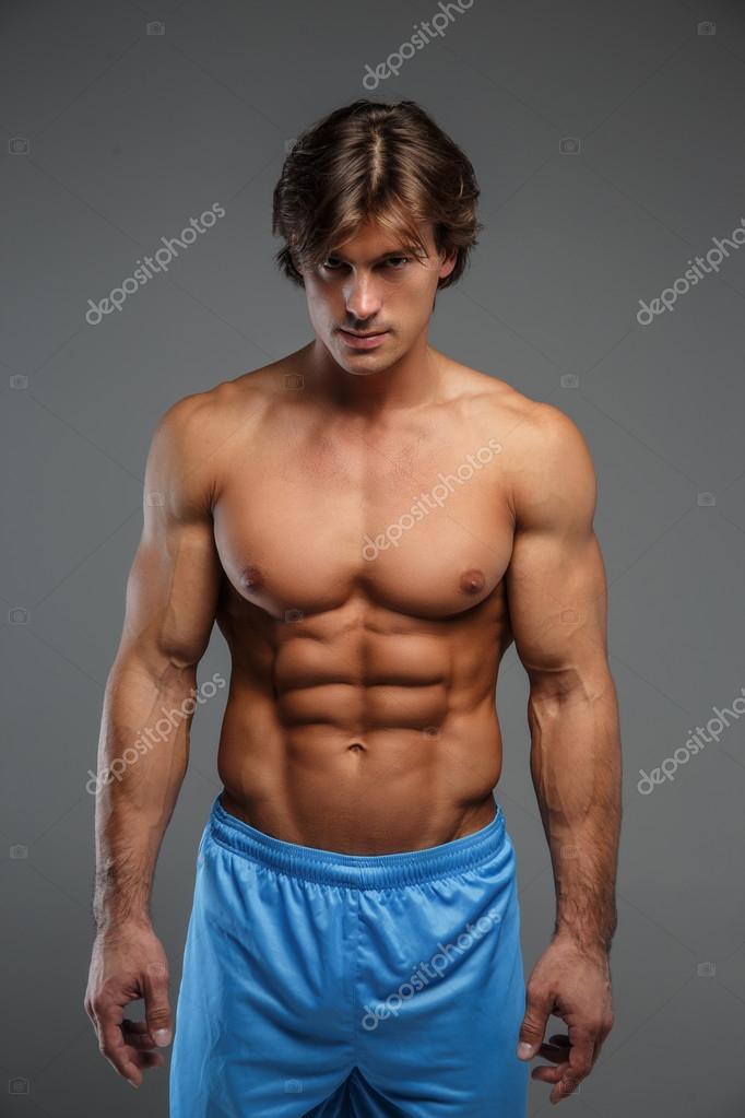 Handsome muscular guy in blue shorts. Stock Photo by ©fxquadro 86472714