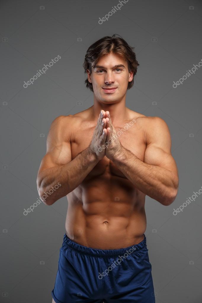 Strong muscular man in blue shorts. Stock Photo by ©fxquadro 86472748