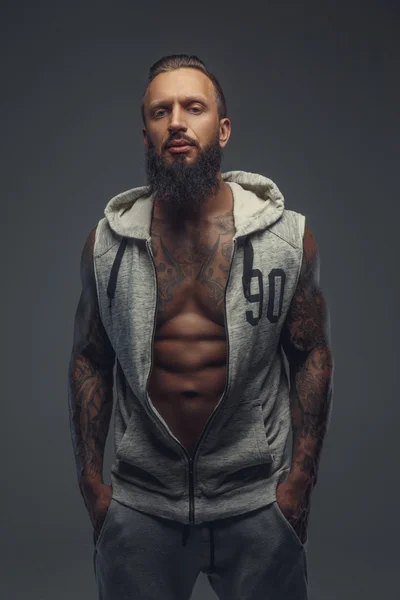 Gangsta tattooed muscular man in a hood. Stock Photo by ©fxquadro 86694144