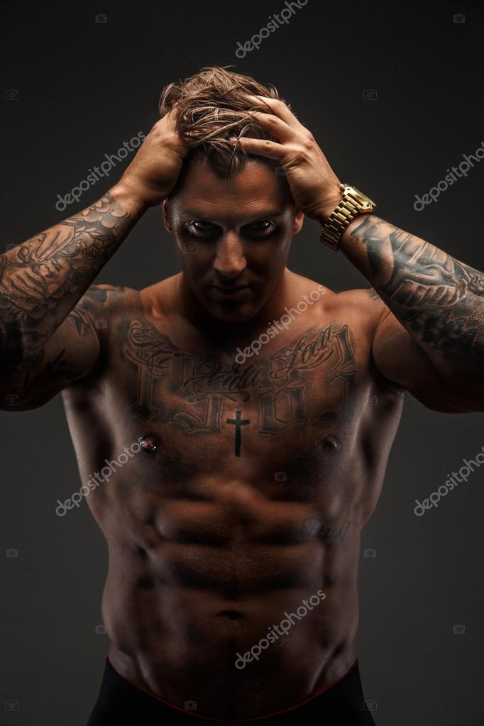 Shirtless muscular tattooed man. Stock Photo by ©fxquadro 86693356