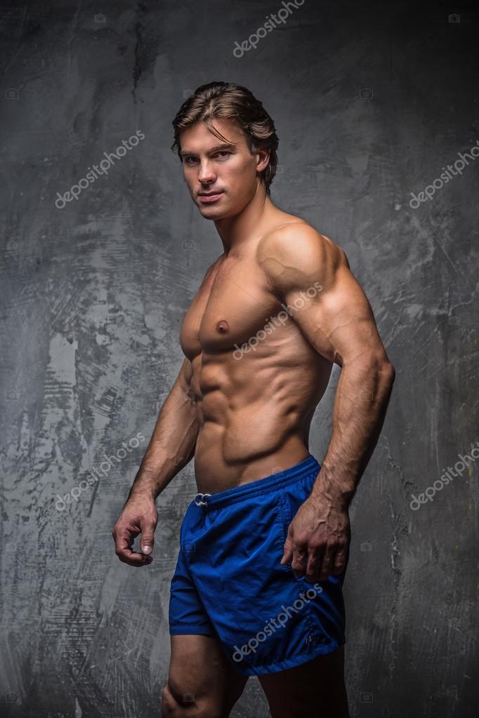 Strong muscular bodybuilder showing his body. Stock Photo by ©fxquadro ...