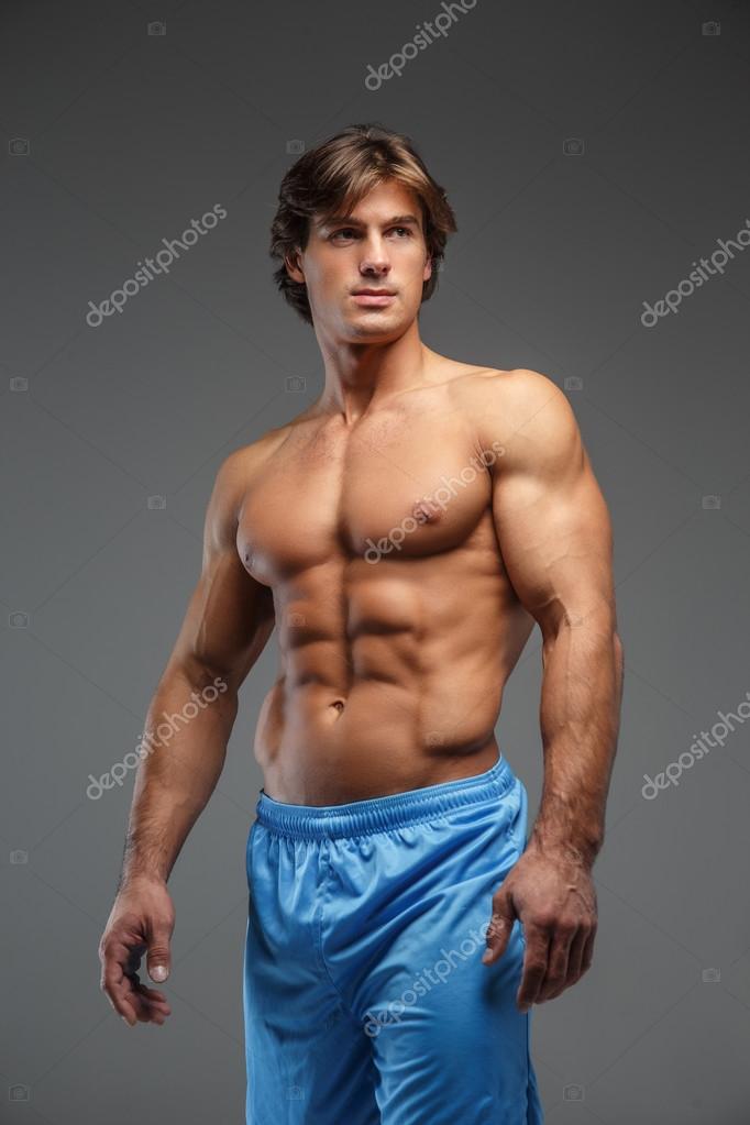 Awesome shirtless bodybuilder in blue shorts. Stock Photo by ©fxquadro ...