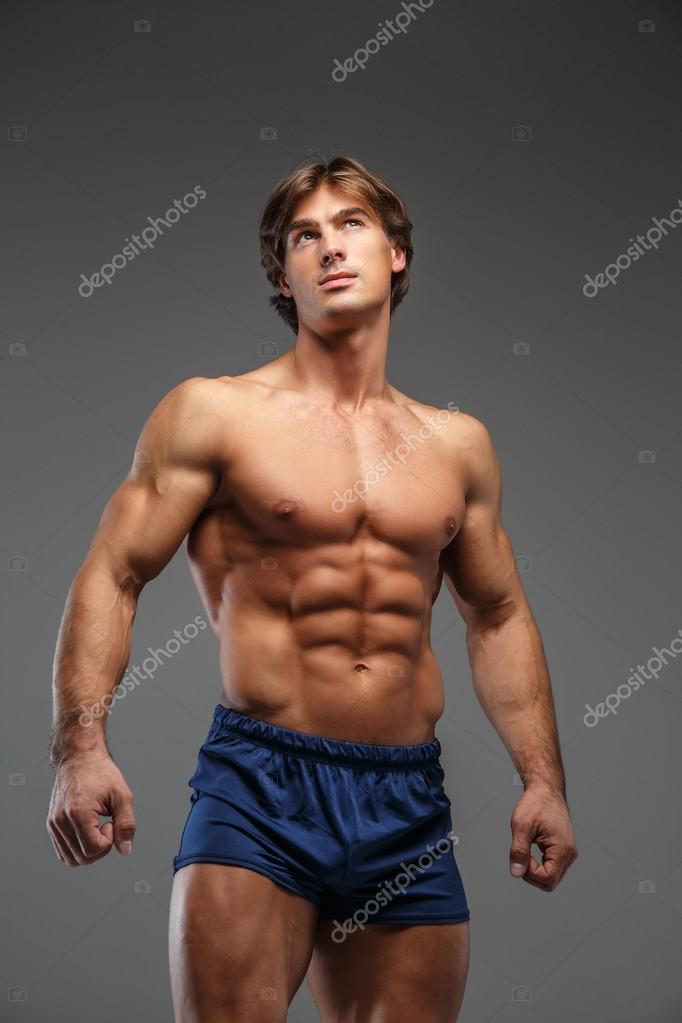 Awesome shirtless bodybuilder in blue shorts. Stock Photo by ©fxquadro ...