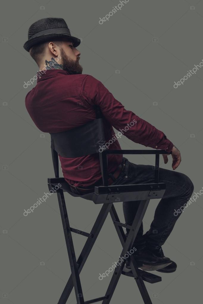 Man in hat sitting on chair. Stock Photo by ©fxquadro 97647828