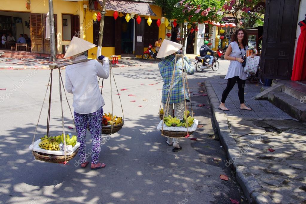 Two women carrying fruit – Stock Editorial Photo © cascoly #70157349