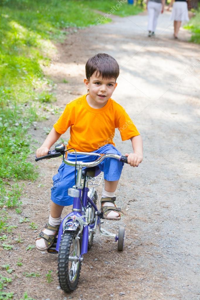 Little boy riding a tricycle — Stock Photo © yanlev #104563162